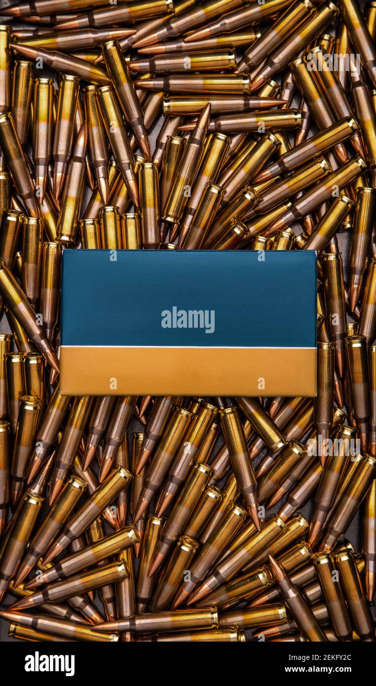 Background from rifle cartridges on a gray metal background. A box of ...