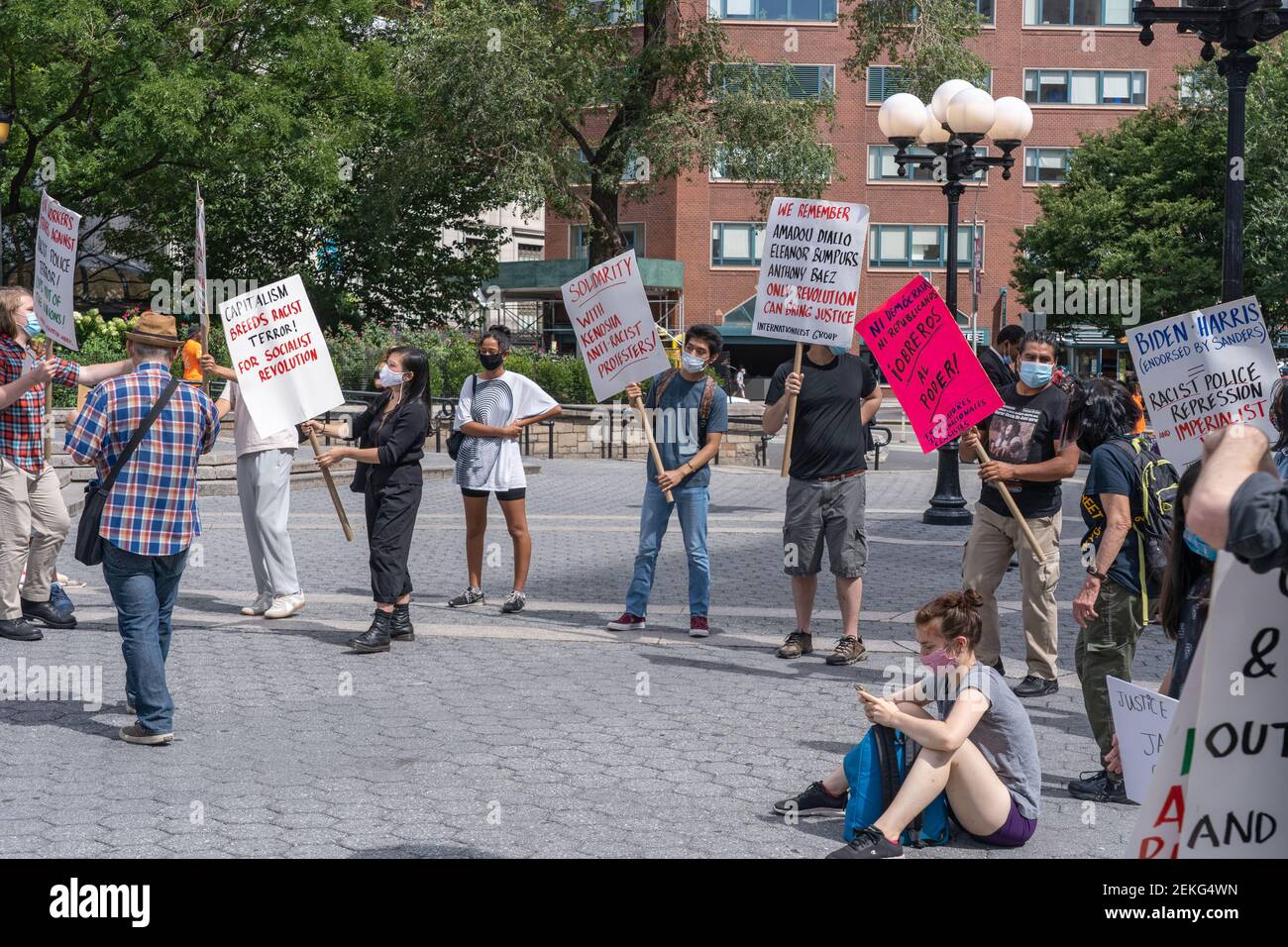 Protesters wearing face mask hold placards during the Internationalist ...