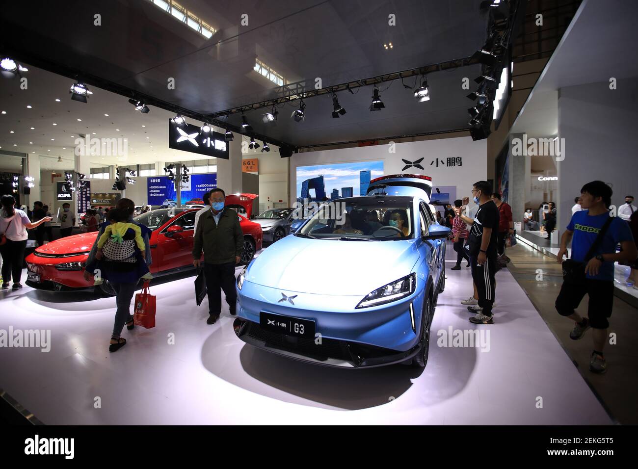 Visitors flock to the booth of XPeng, also known as Xiaopeng Motors, a ...