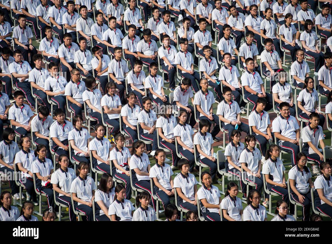Students sit on chairs attending a lecture at a primary school in Wuhan ...