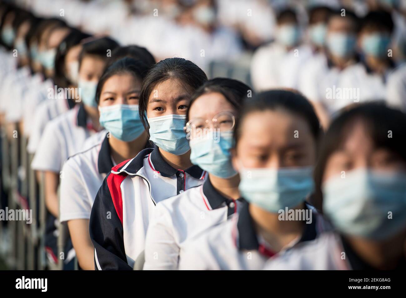 Students sit on chairs attending a lecture at a primary school in Wuhan ...