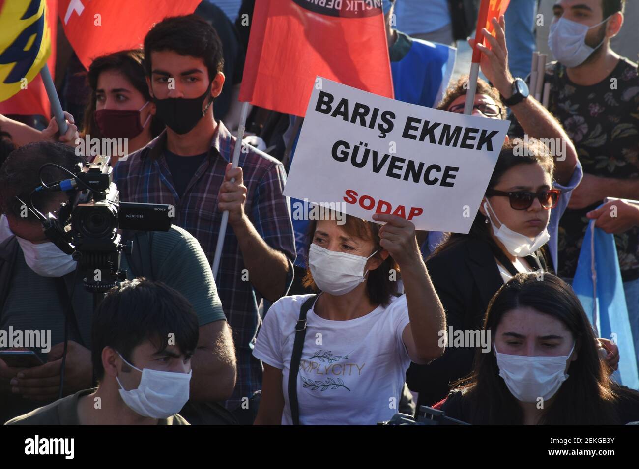 A women holds a placard against war during a Global Peace Chain rally ...