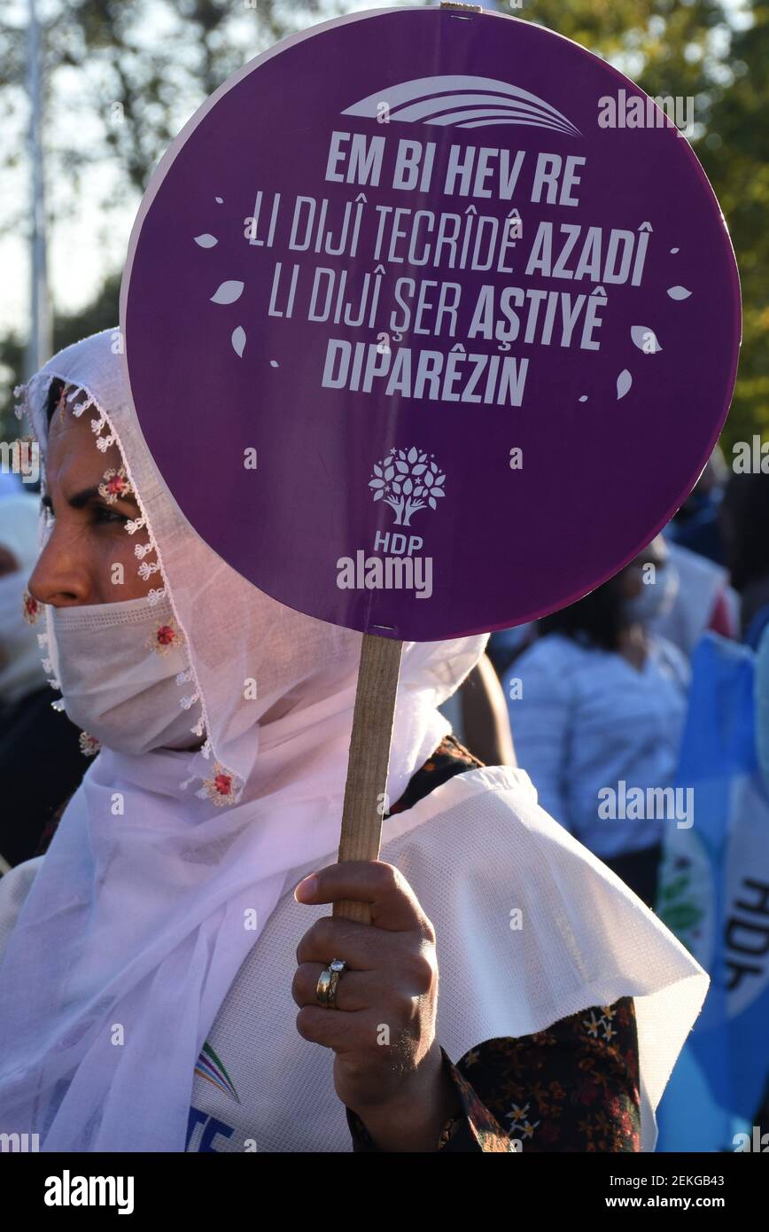 A women holds a placard against war during a Global Peace Chain rally ...