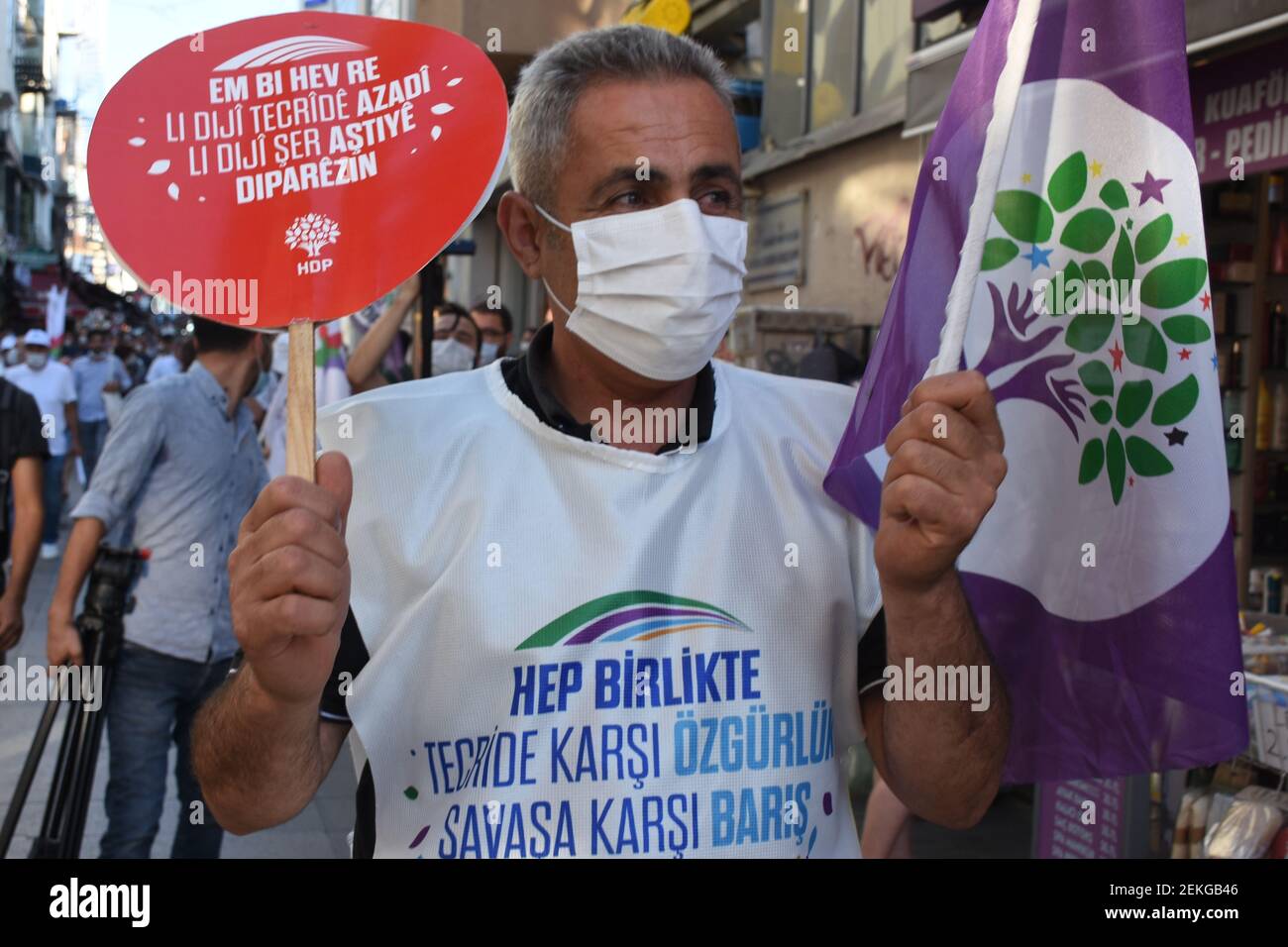 A man holds a banner against war during a Global Peace Chain rally in ...