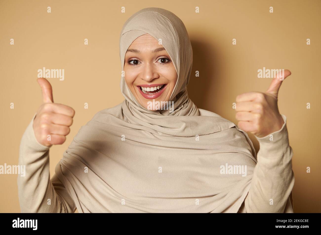 Happy Arab muslim woman in hijab with a beautiful toothy smile showing ...