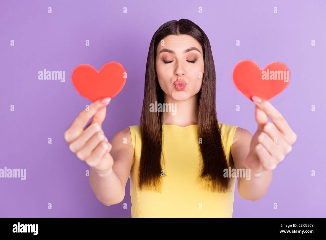 Portrait Of Attractive Affectionate Girl Holding In Hands Two Heart