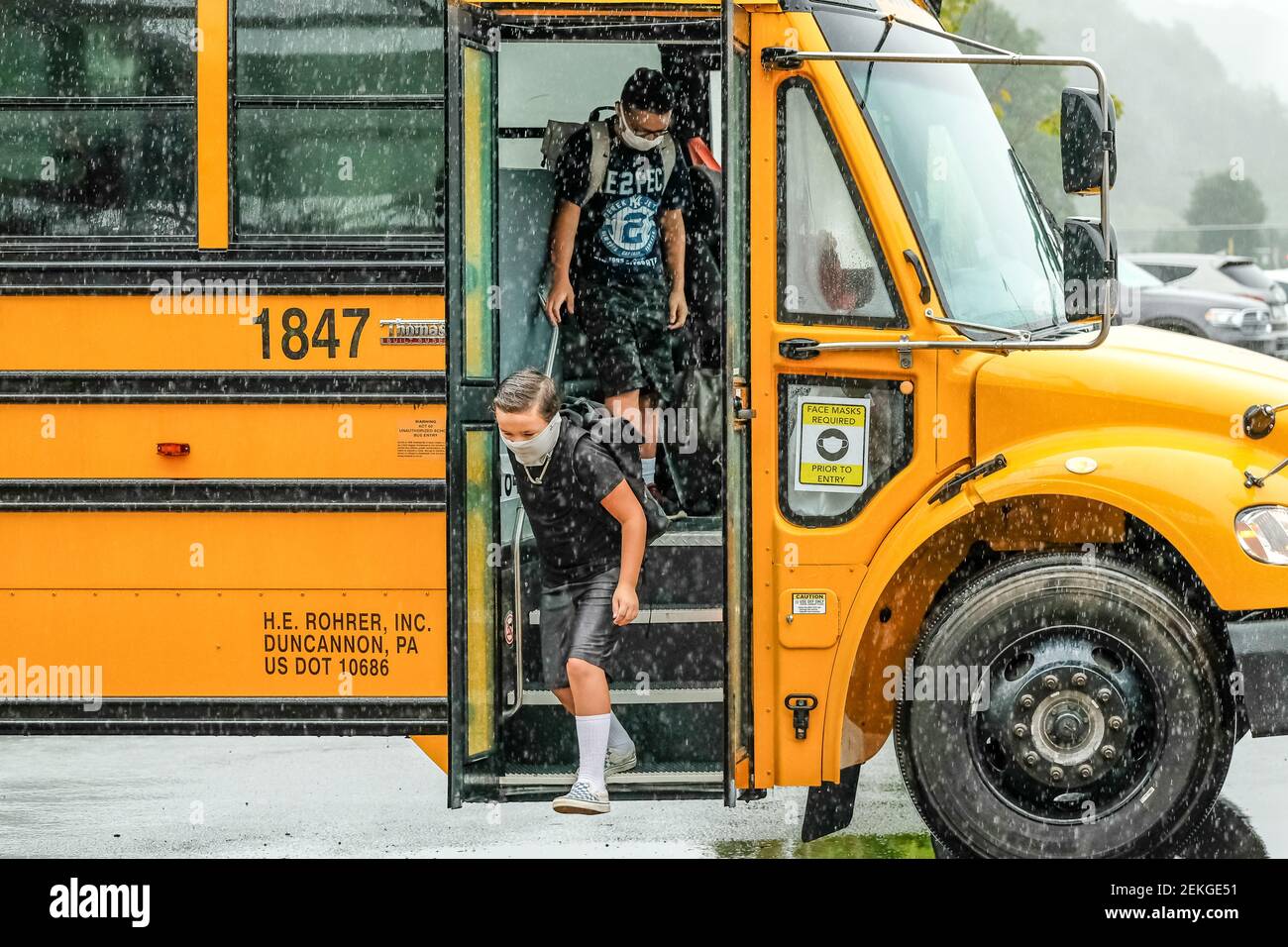 Students wearing face masks as a preventive measure arrive at Delaware Valley High School during ...