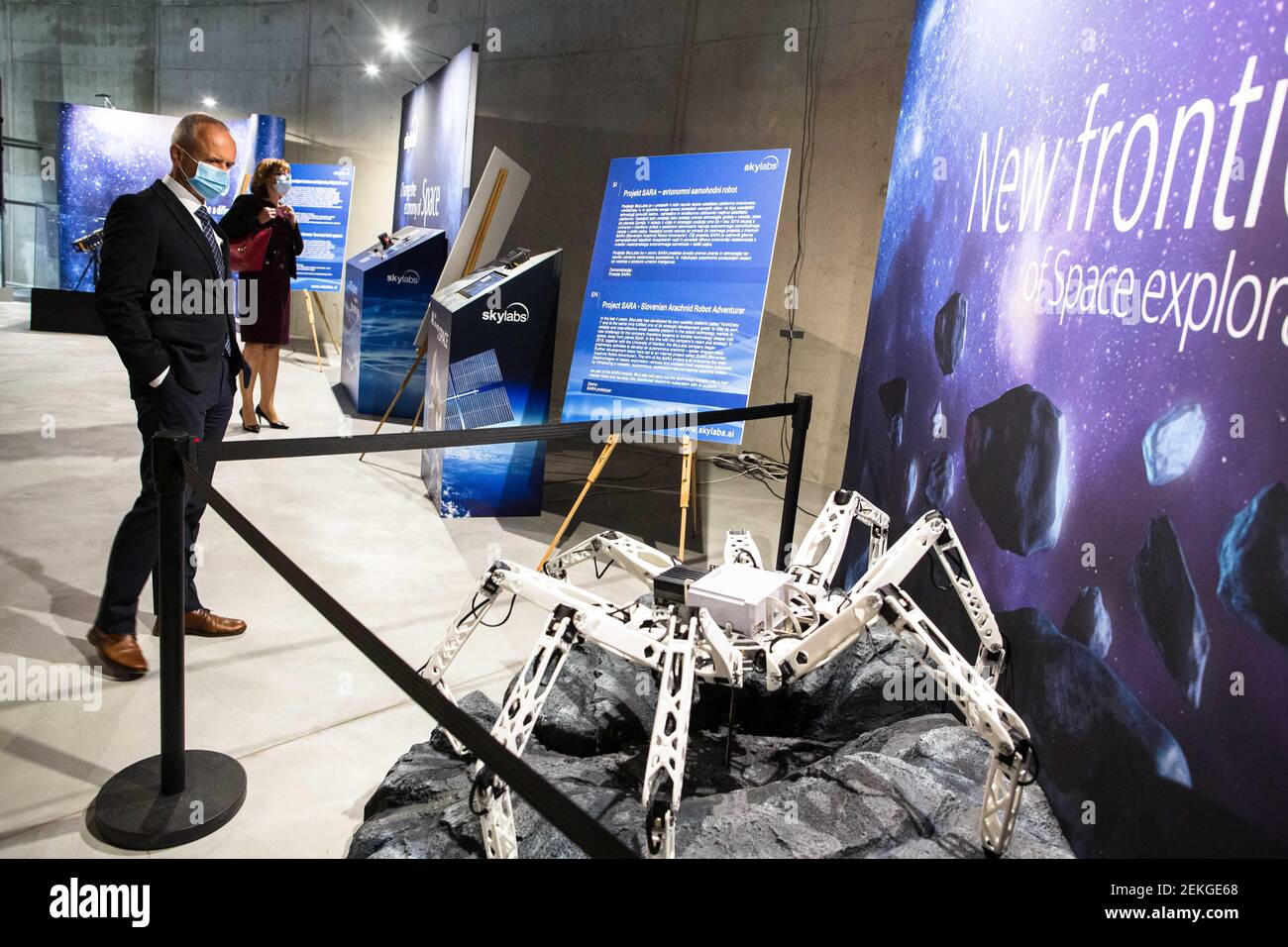 A visitor wearing a facemask observes a Slovenian lunar robot named ...