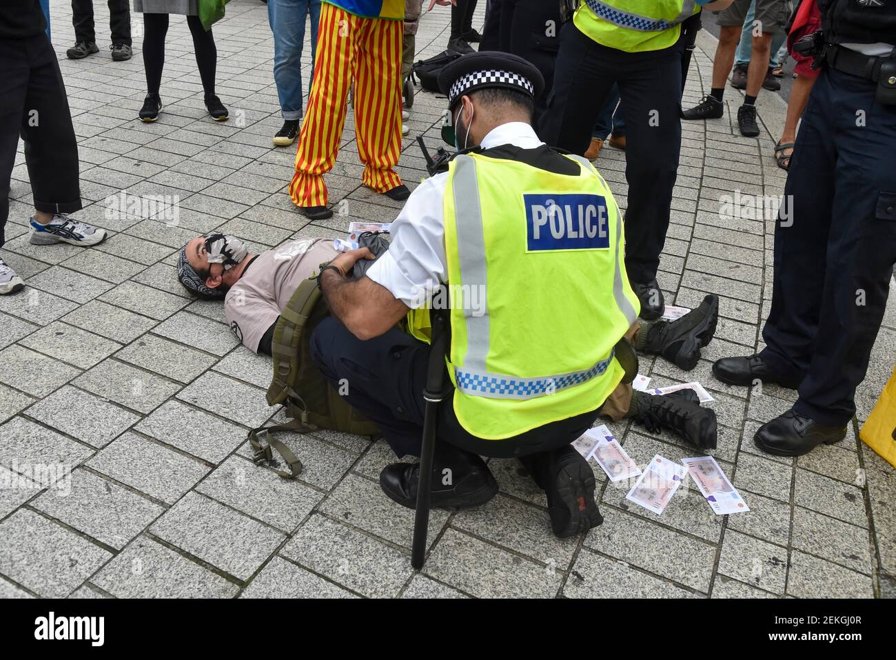 Police arrest a protester at Trafalgar Square during the demonstration ...