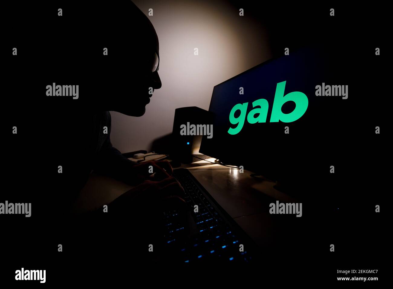 A man is seen surfing on the Gab social media platform in Warsaw ...