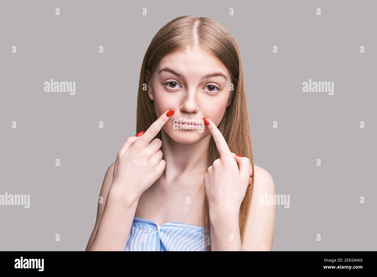 Girl point at nose High Resolution Stock Photography and Images - Alamy
