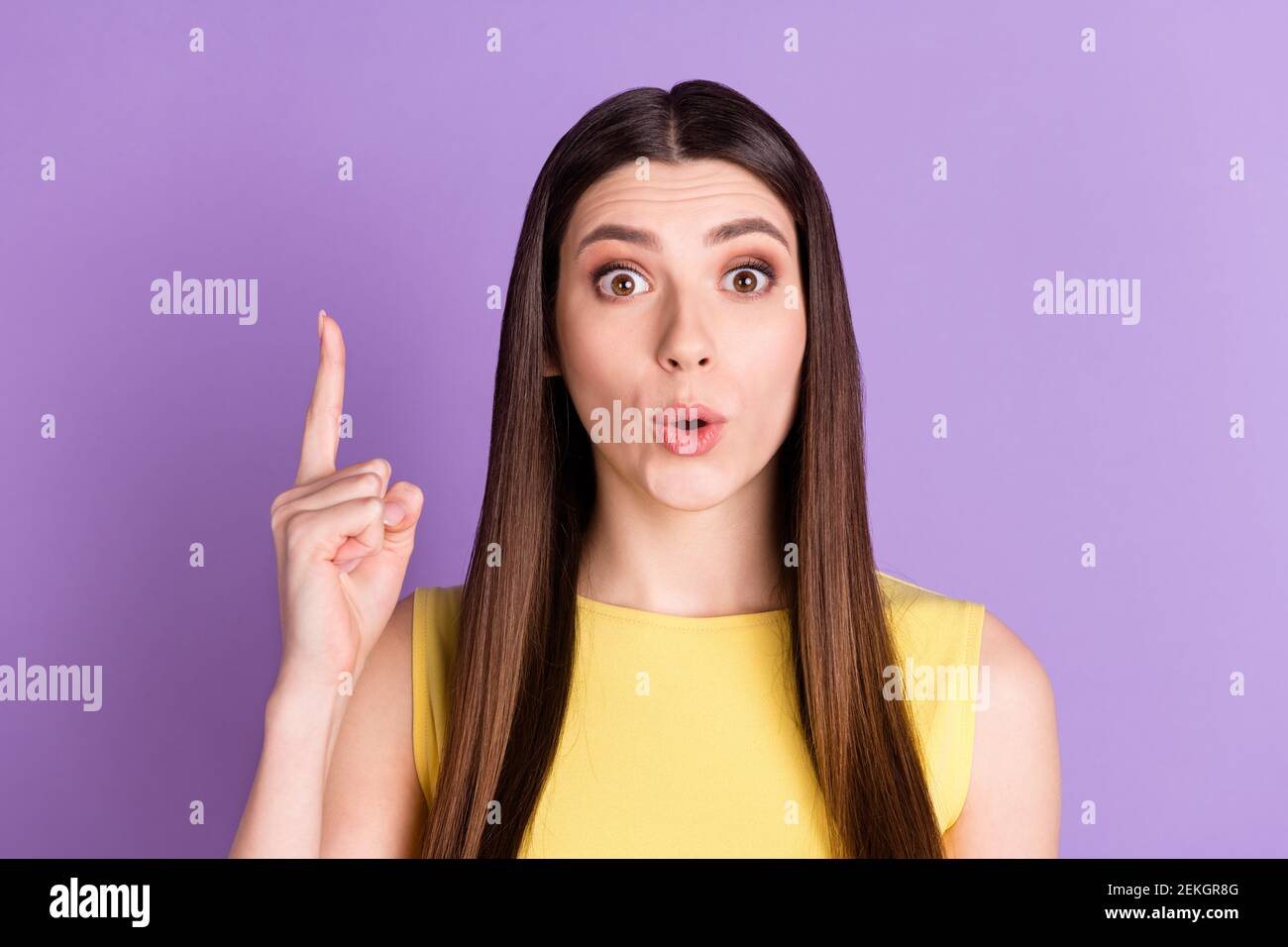 Portrait of attractive amazed brainy girl pointing forefinger up copy ...