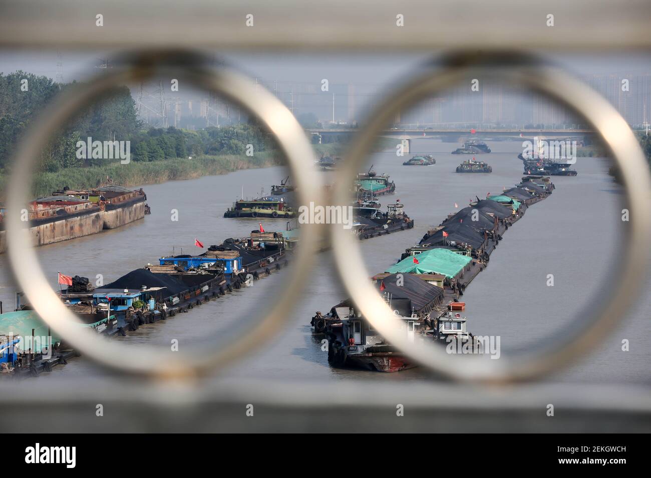 An aerial view of ships containing various kinds of goods moving on the ...