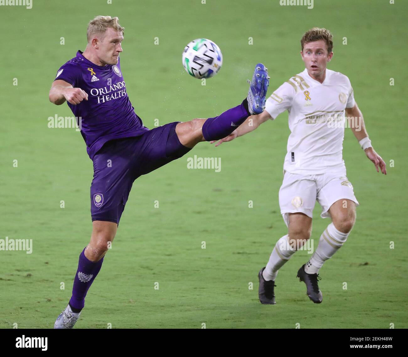 Orlando City's Robin Jansson, left, gets a foot to the ball against ...
