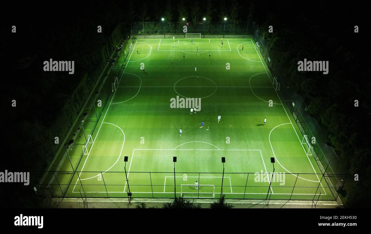 An aerial view of citizens doing exercise at an outdoor sports field ...