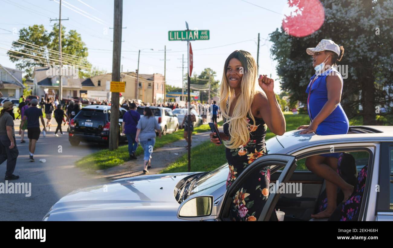 Two women watch from their vehicle as protesters march from South ...