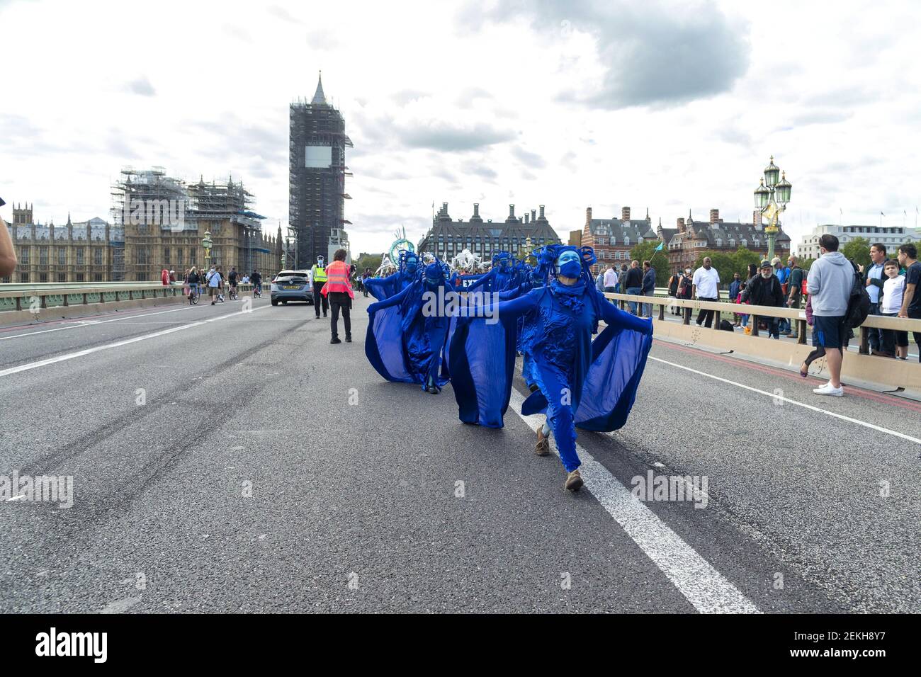 Protesters wear blue outfits to represent the ocean during the ...