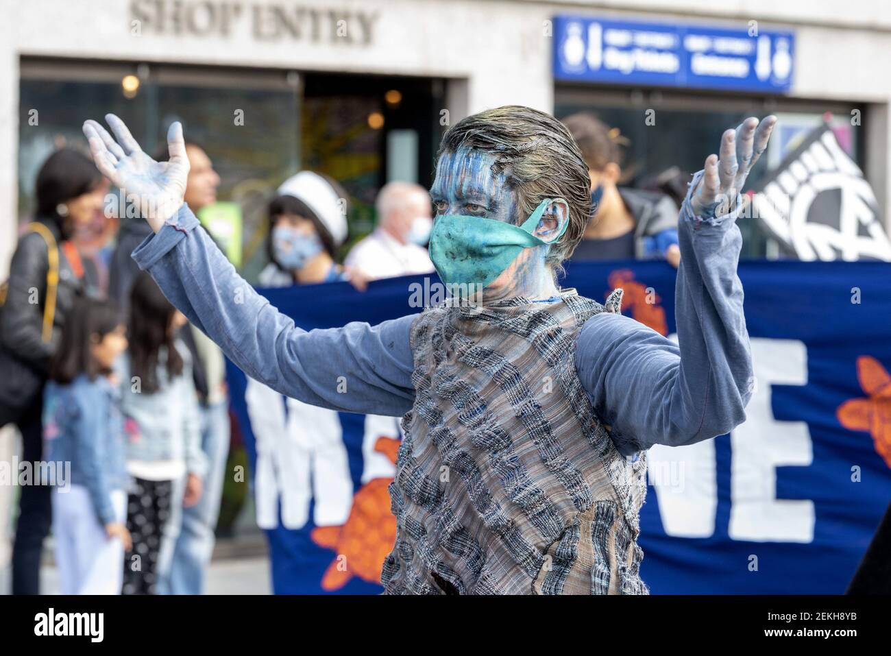 A protester dressed to represent pollution in the oceans takes part ...