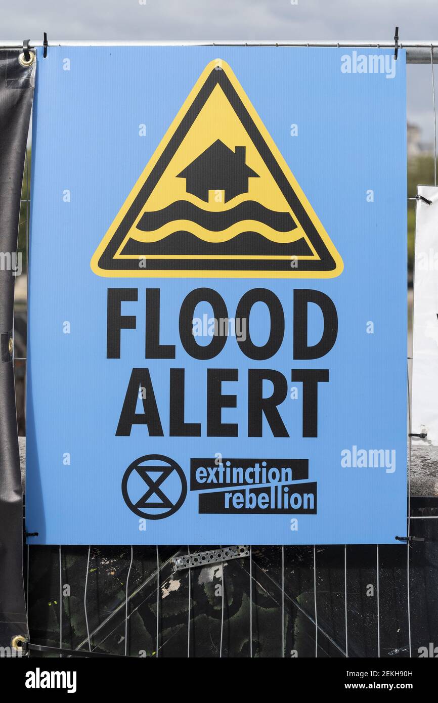 A ‘Flood Alert’ placard during the Extinction Rebellion Macabre Beach ...