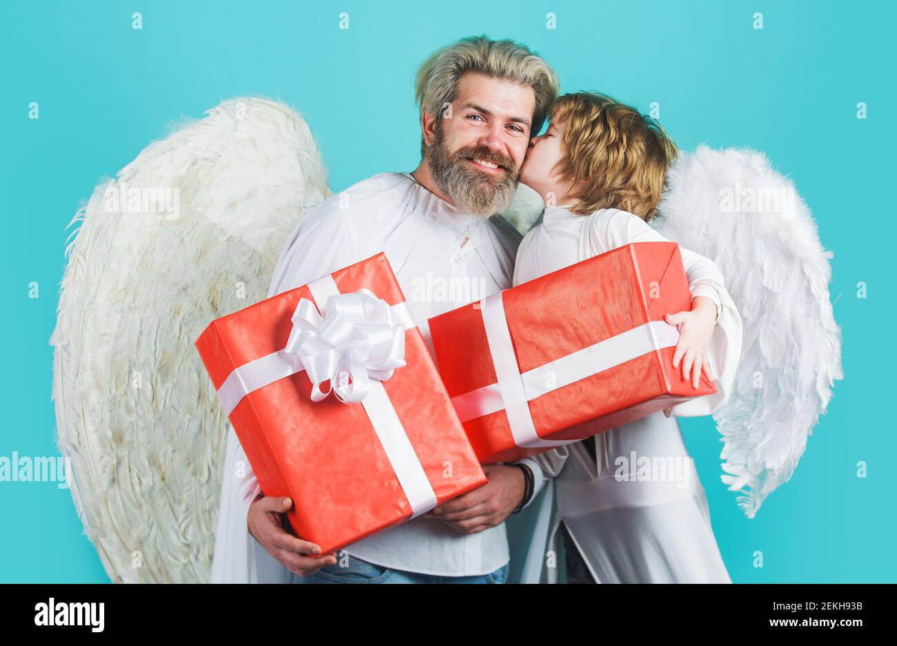 Happy father with little son in angel costumes with gifts. Valentines ...