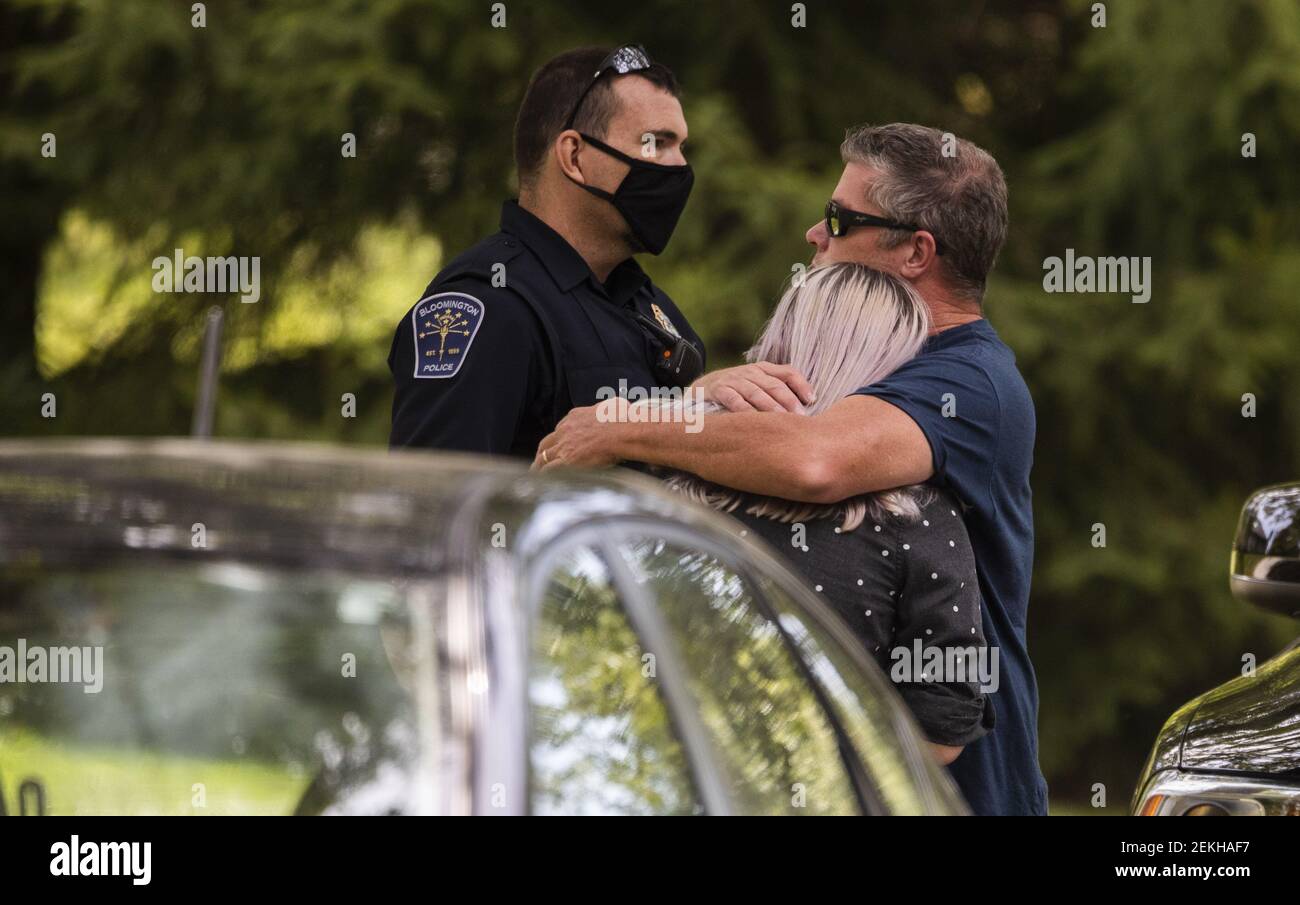 A woman is being comforted at the site of a triple murder-suicide that ...
