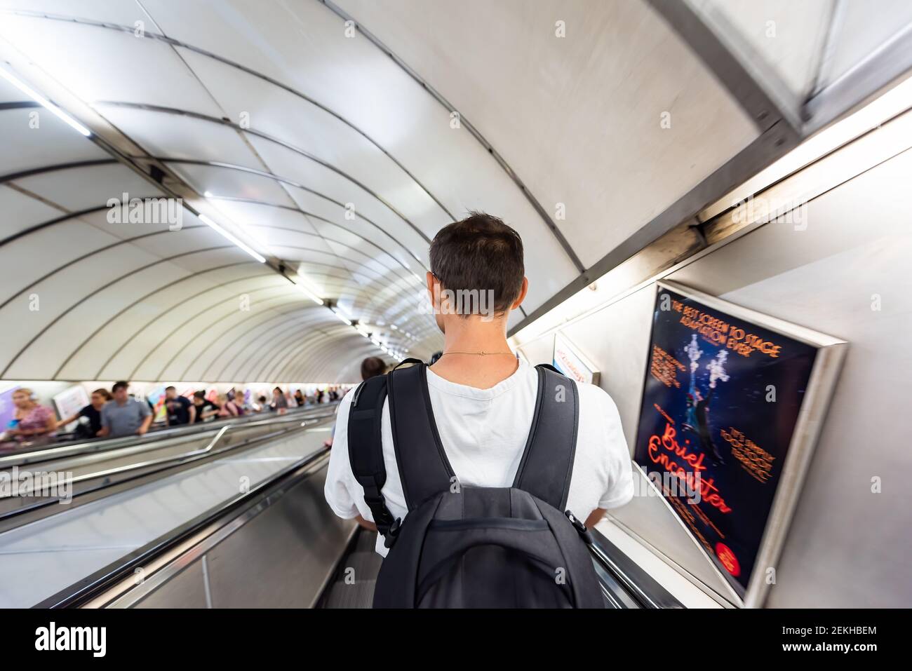 London, UK - June 26, 2018: People man back riding escalator down ...