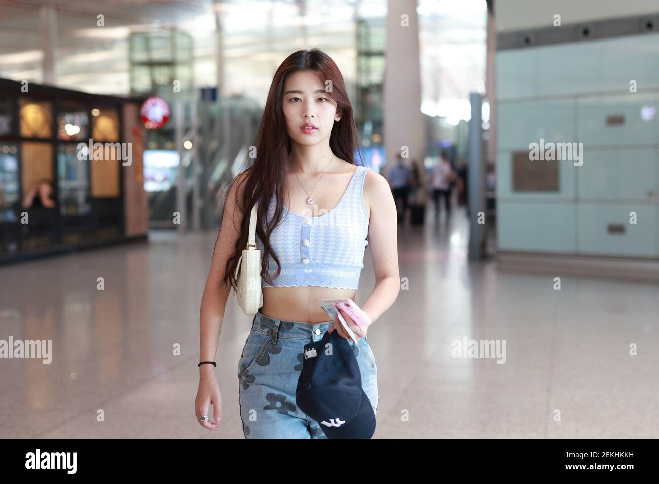 Chinese singer Zuo Zhuo, dressed in suspender vest and jeans, shows off ...