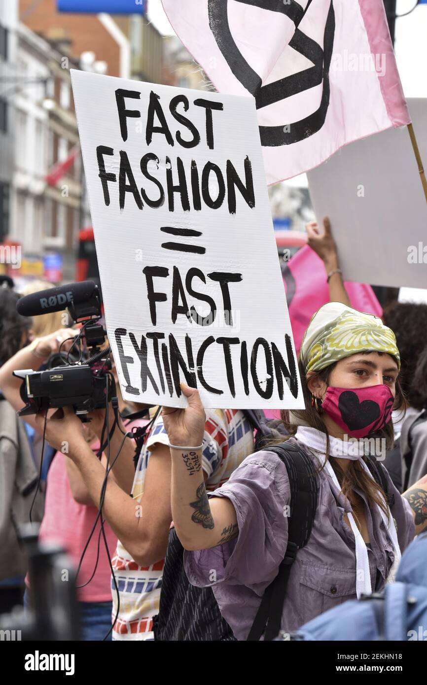 Protester wearing a face mask holding a placard expressing her opinion ...