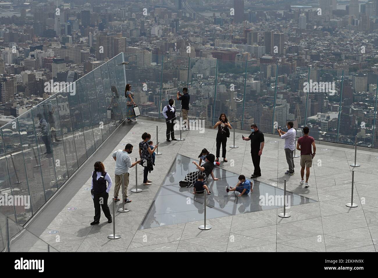 People take turns sitting on the glass floor at Edge, the new ...