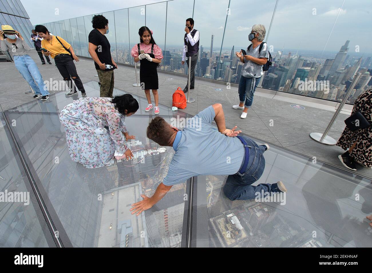 People take turns sitting on the glass floor at Edge, the new ...