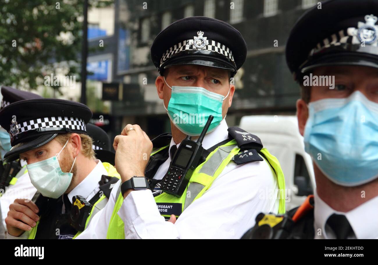 Police officers wear face masks as they patrol a protest ground in ...