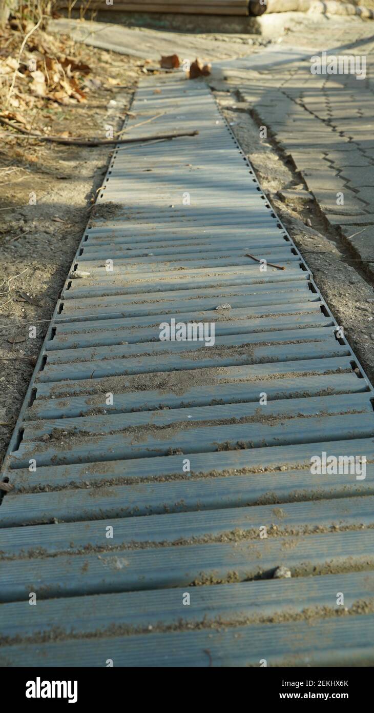 Metal Ditch Cover on the Park Ground Stock Photo - Alamy