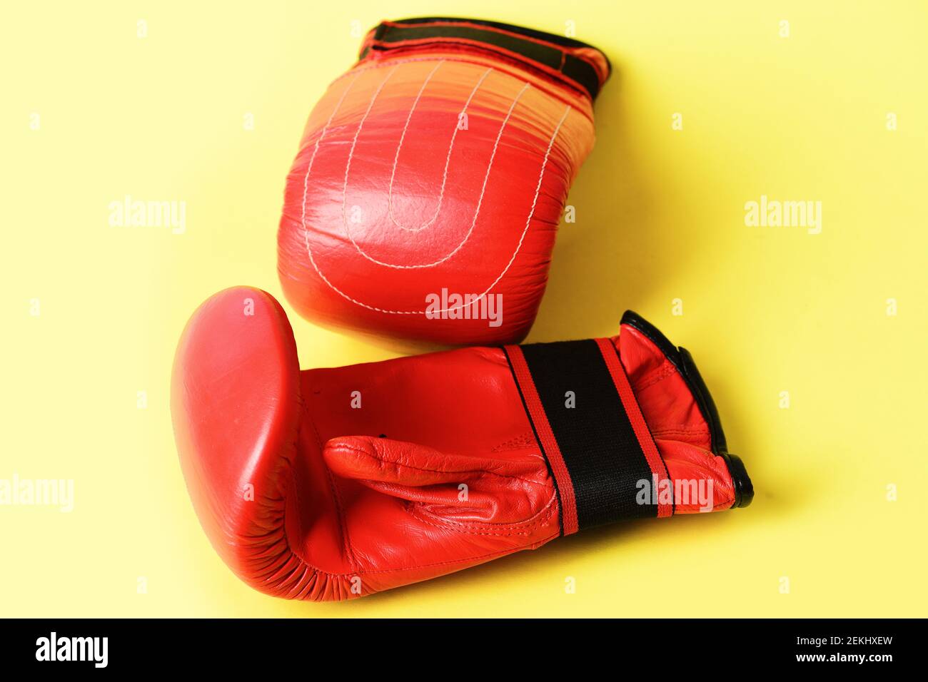 Mittens for boxing in red color isolated on deep yellow background ...