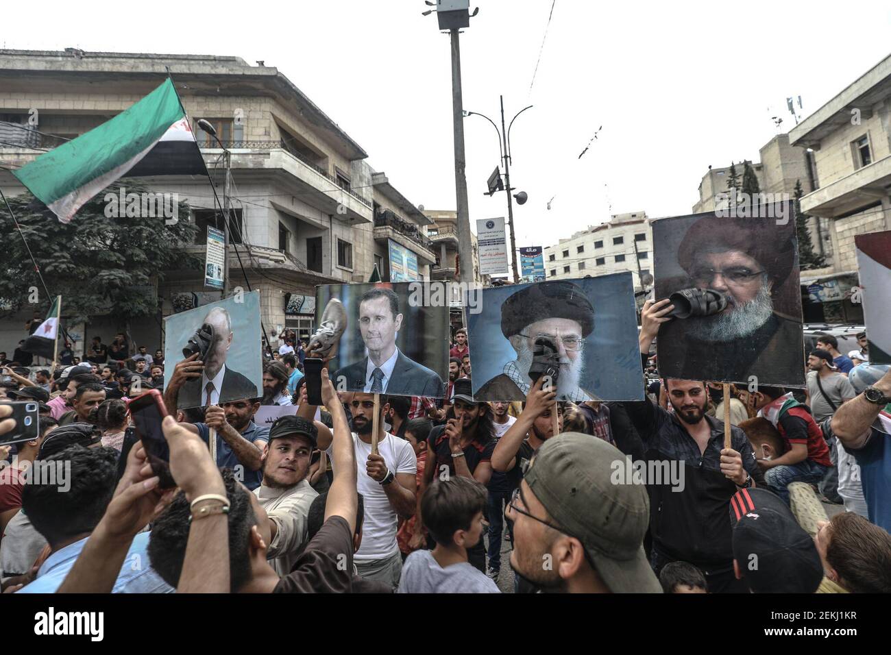 Syrians holds posters during a demonstration against President Bashar ...