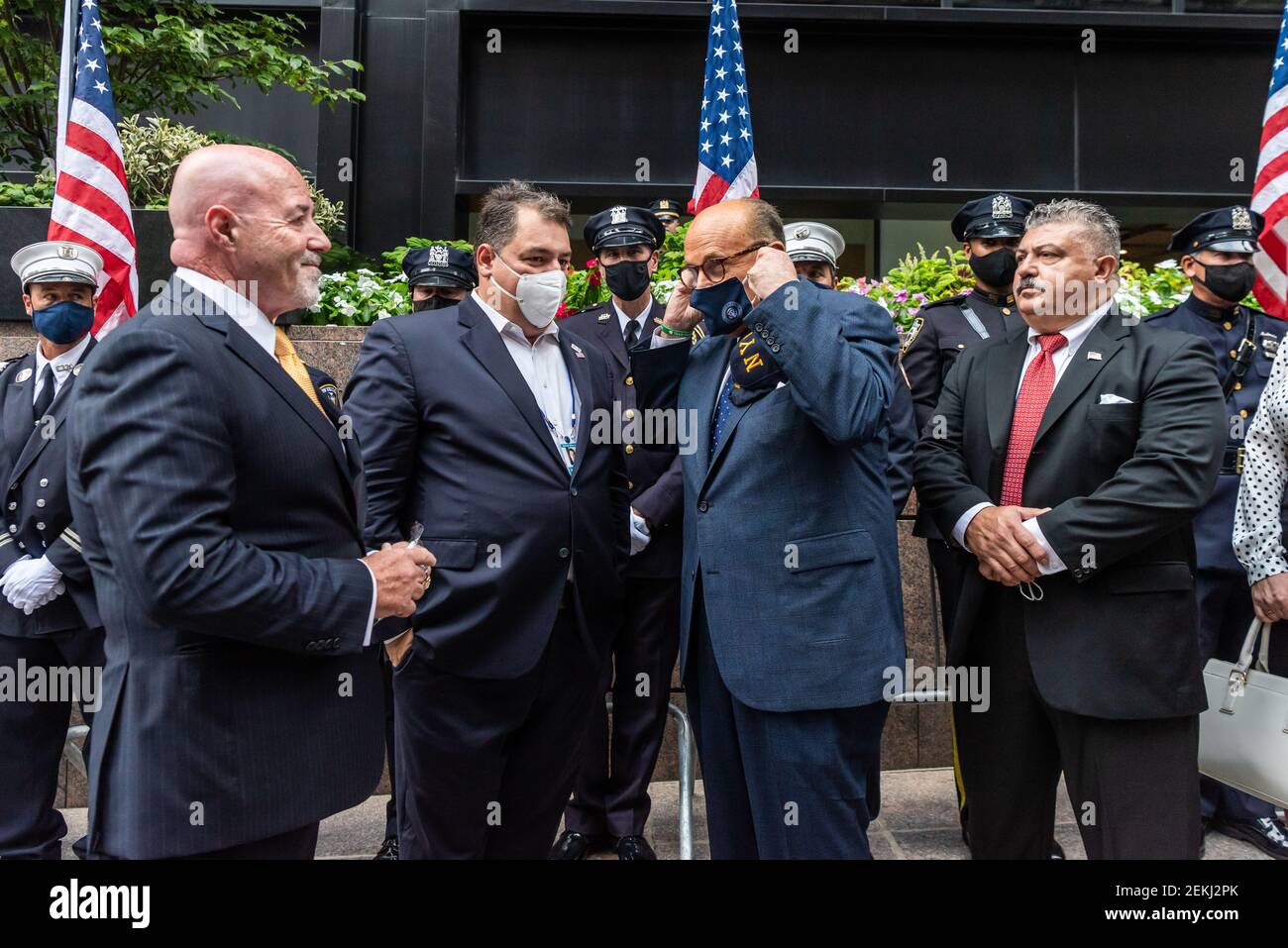 Former New York City Mayor Rudi Giuliani puts on a face mask while ...