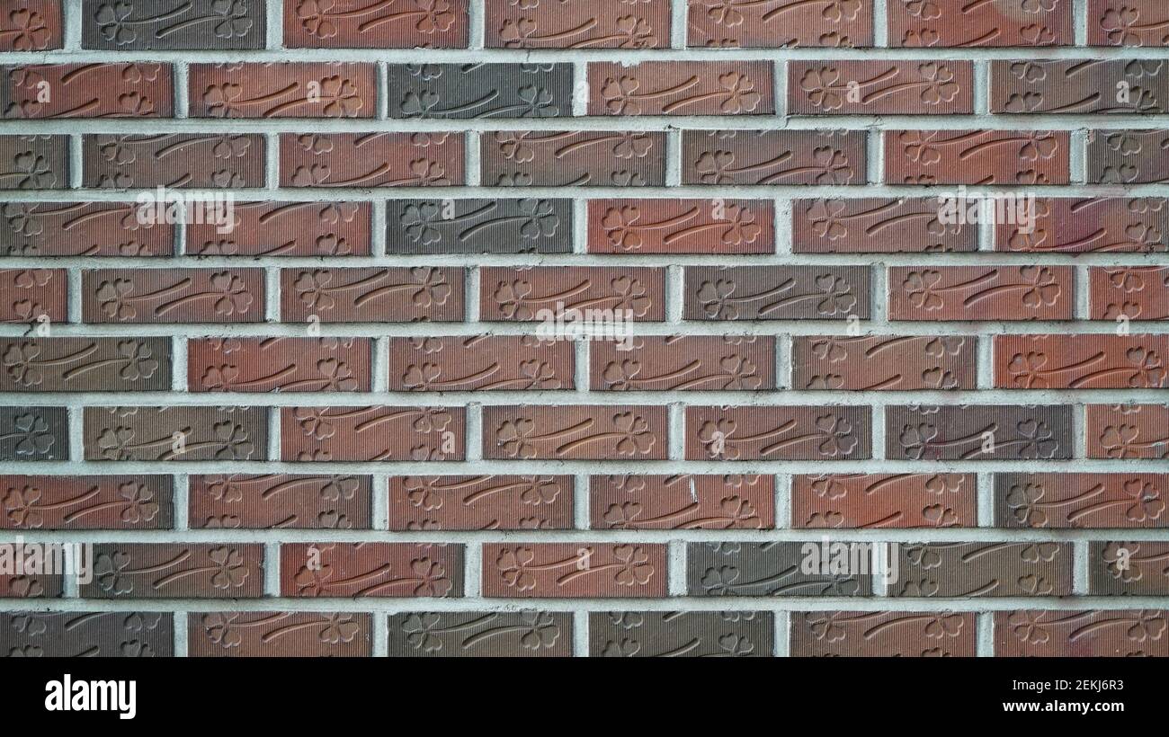 Red brick wall texture with four leaf clover pattern Stock Photo - Alamy
