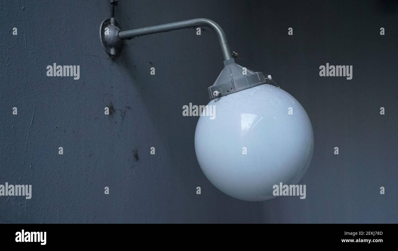 A large spherical light bulb on the wall Stock Photo - Alamy