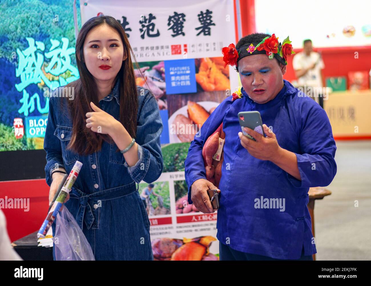 Livestreamers introduce products at a livestreaming booth set up at the ...
