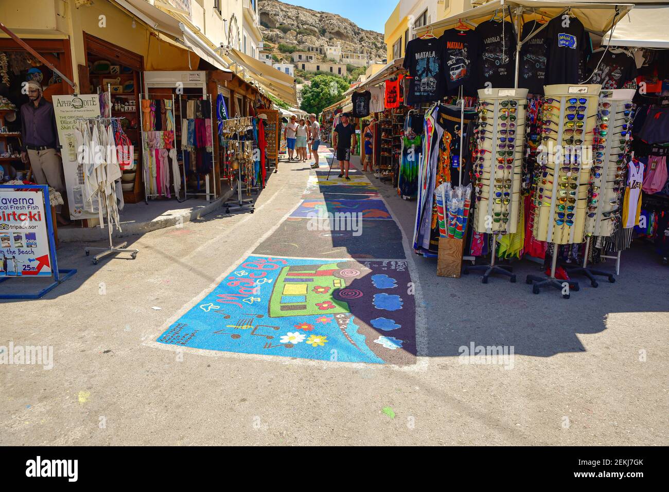 Matala, Greece - June 18, 2018: Unidentified people, shops, restaurant ...