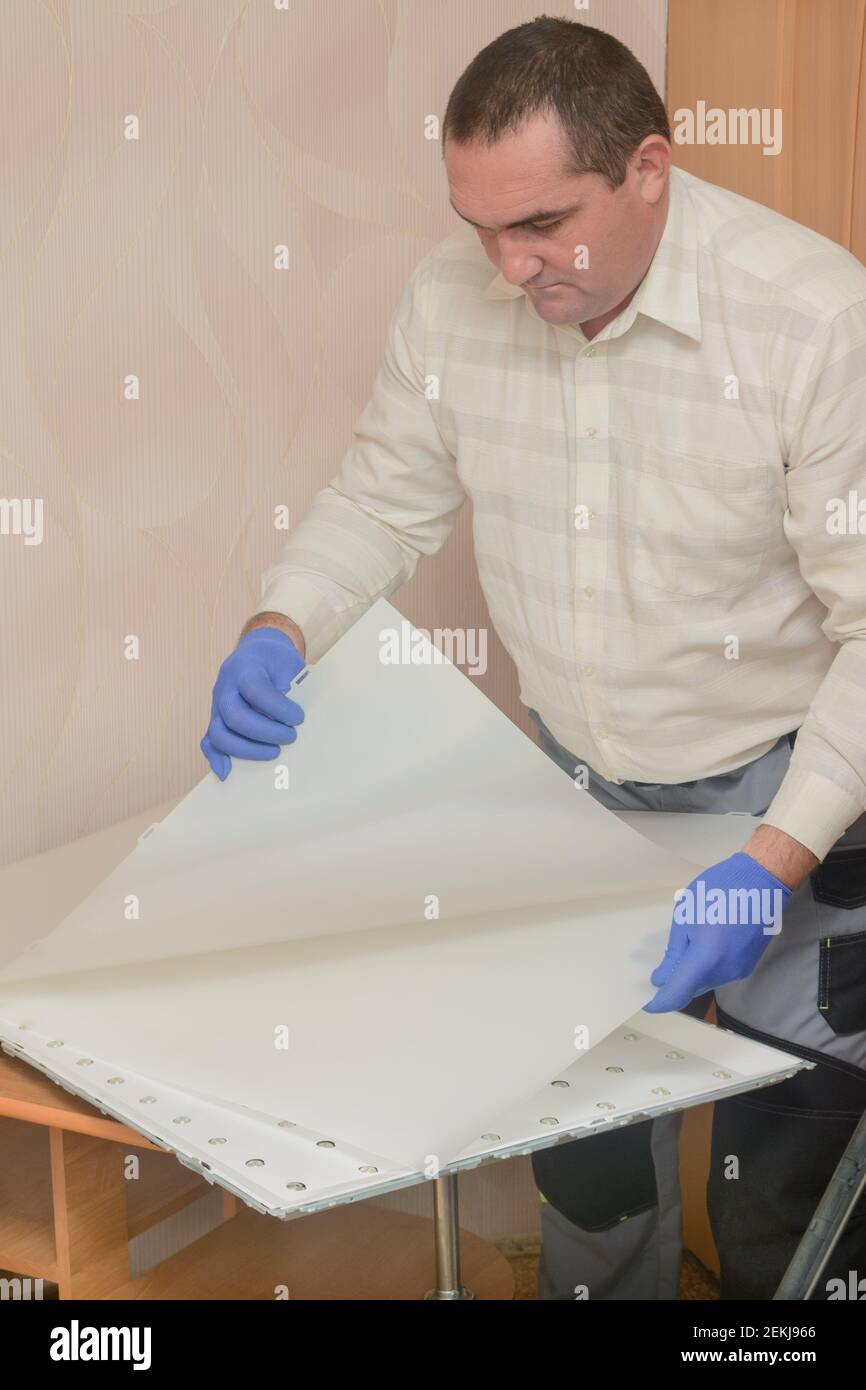 Repair of LCD TV at home. Master disassembles lens and diffuser sheets ...