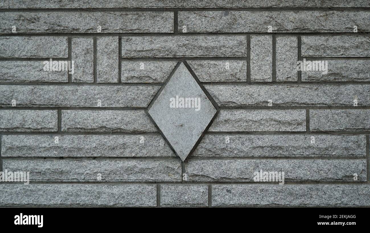 Stone wall with a diamond shape in the middle Stock Photo - Alamy