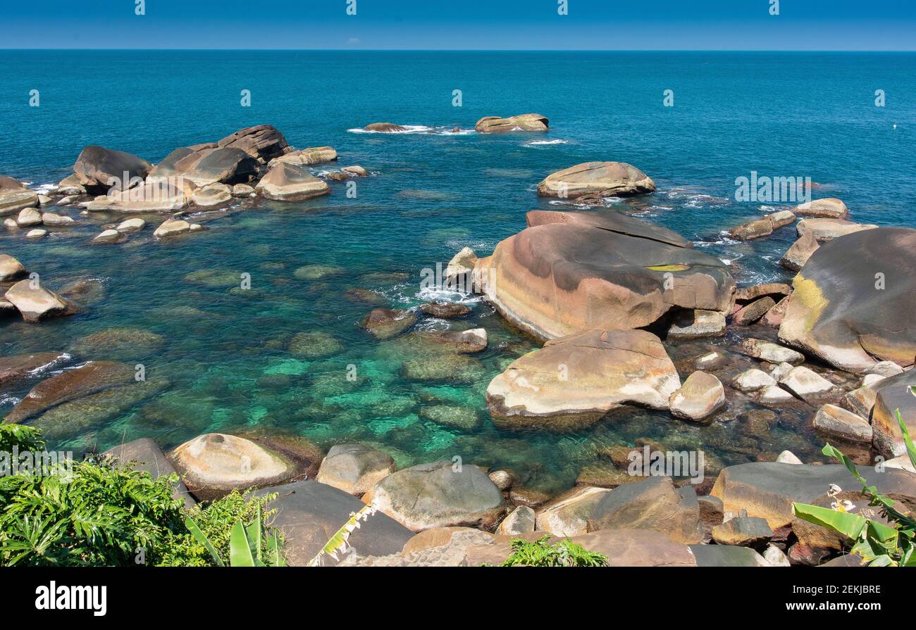 Green and blue ocean beach. Rock beach at Ilhabela island, Brazil Stock ...