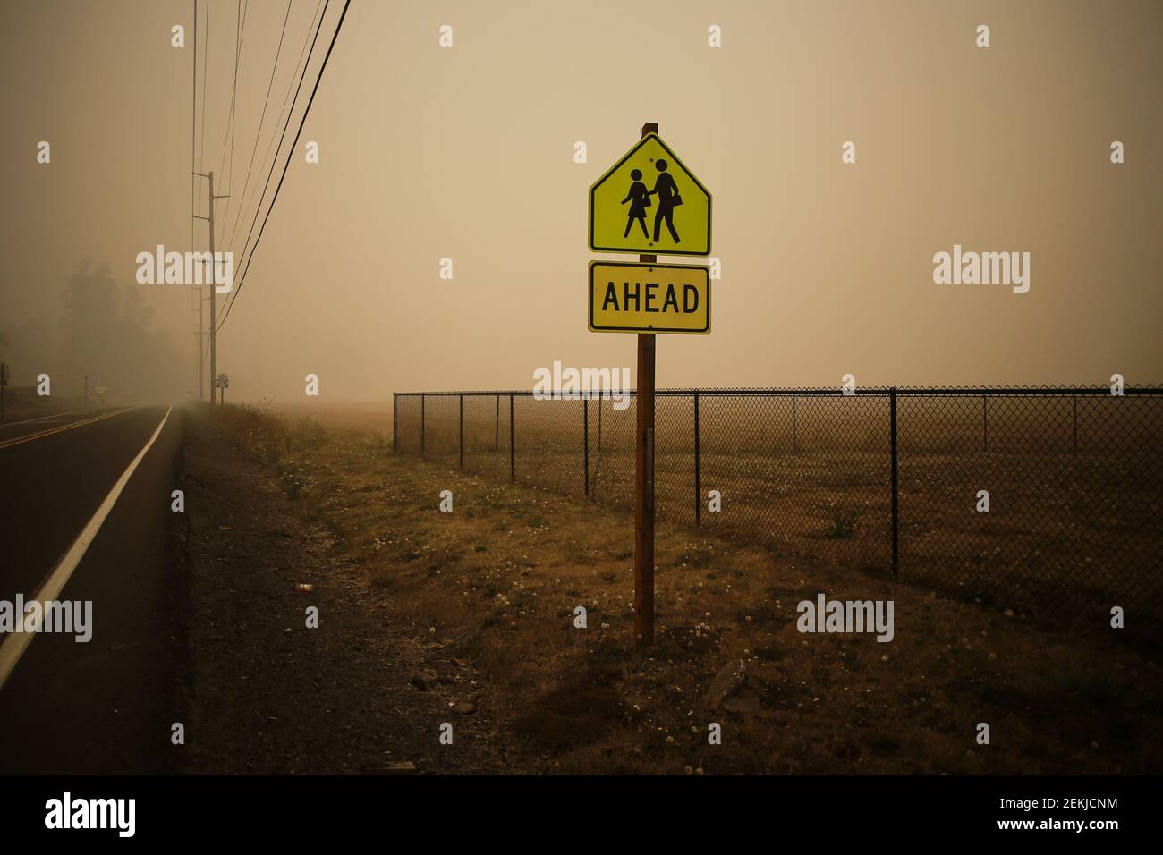 A pedestrian crossing sign is being surrounded by smoke from the ...