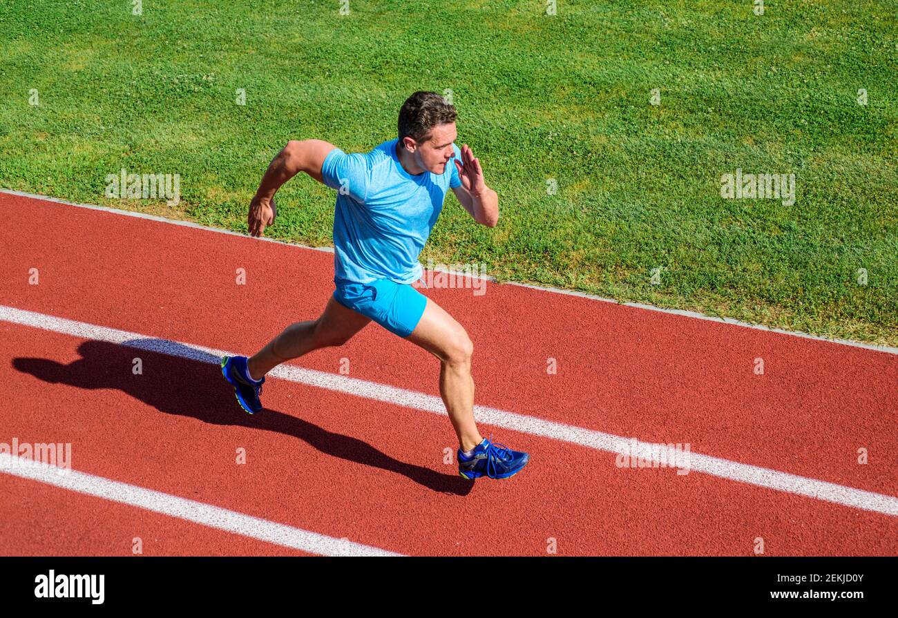 Impulse to move. Athlete run stadium green grass background. Life non ...