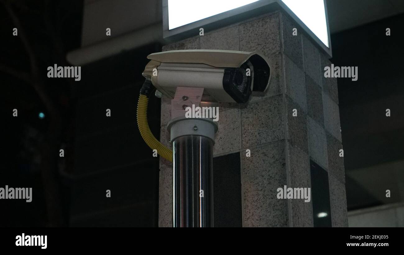 CCTV Camera in Front of Street Buildings at Night Stock Photo - Alamy