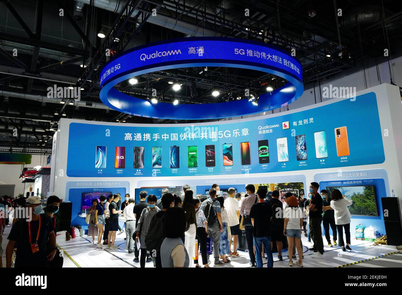 In this unlocated photo, visitors gather at the booth of Qualcomm, an ...