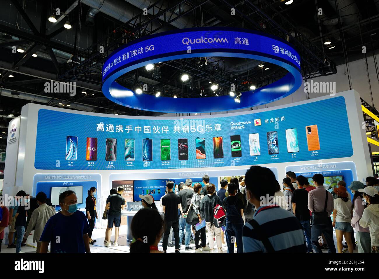 In this unlocated photo, visitors gather at the booth of Qualcomm, an ...