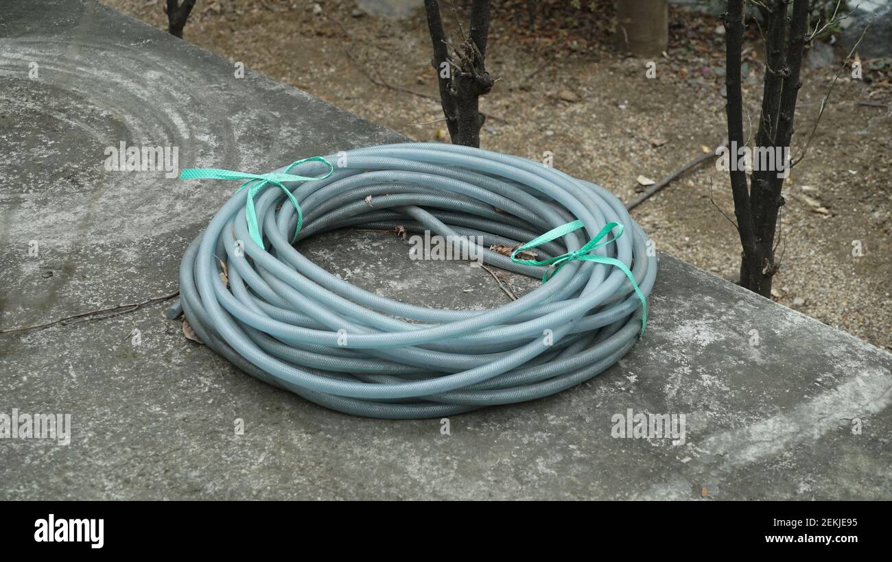 Wound hose on the Concrete Structure Stock Photo - Alamy