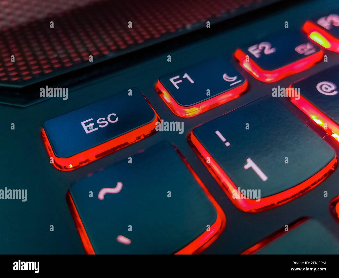 Keyboard of laptop highlighted by red lights Stock Photo - Alamy