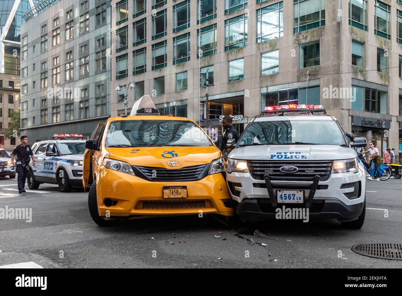 An NYPD cruiser and a yellow cab collide on Broadway and 58th Street in ...